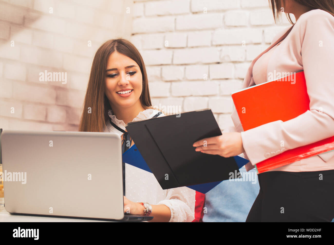Job interview. Beautiful young woman giving a curriculum vitae to his ...