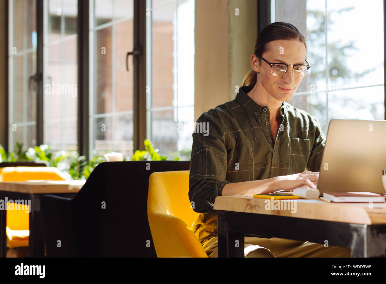 Positive good looking man being busy with work Stock Photo - Alamy