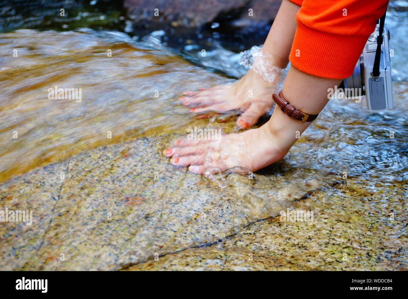 Women hand washing in stream hi-res stock photography and images - Alamy