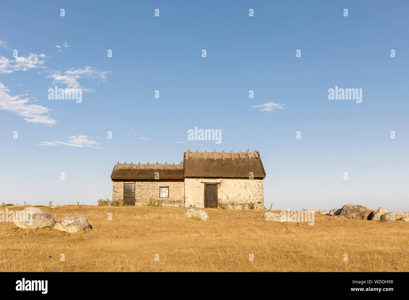 Stone buildings in field Stock Photo - Alamy