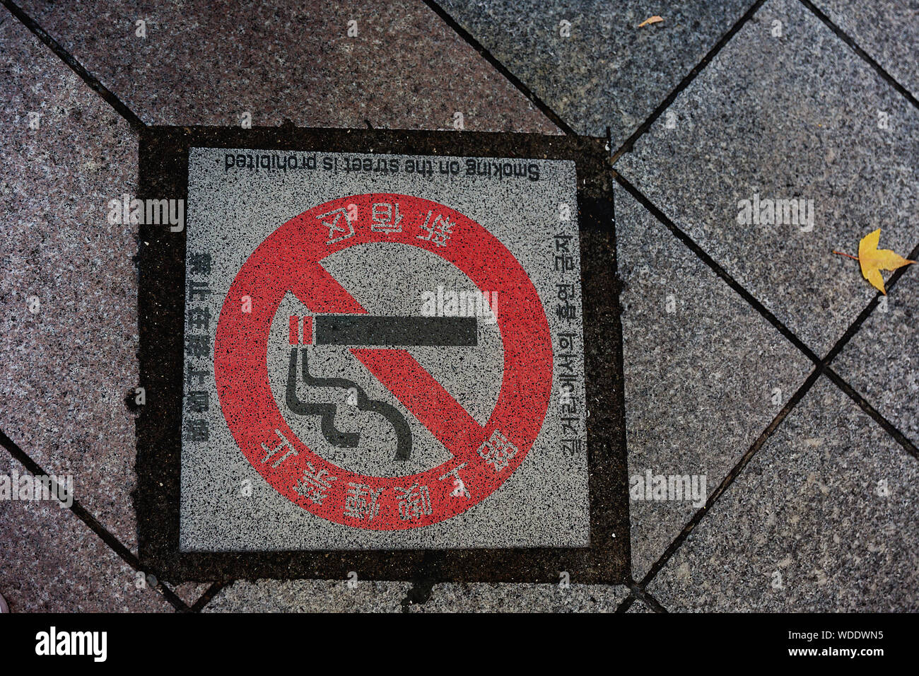 "Smoking in the street is prohibited" sign located in Tokyo sidewalk ...