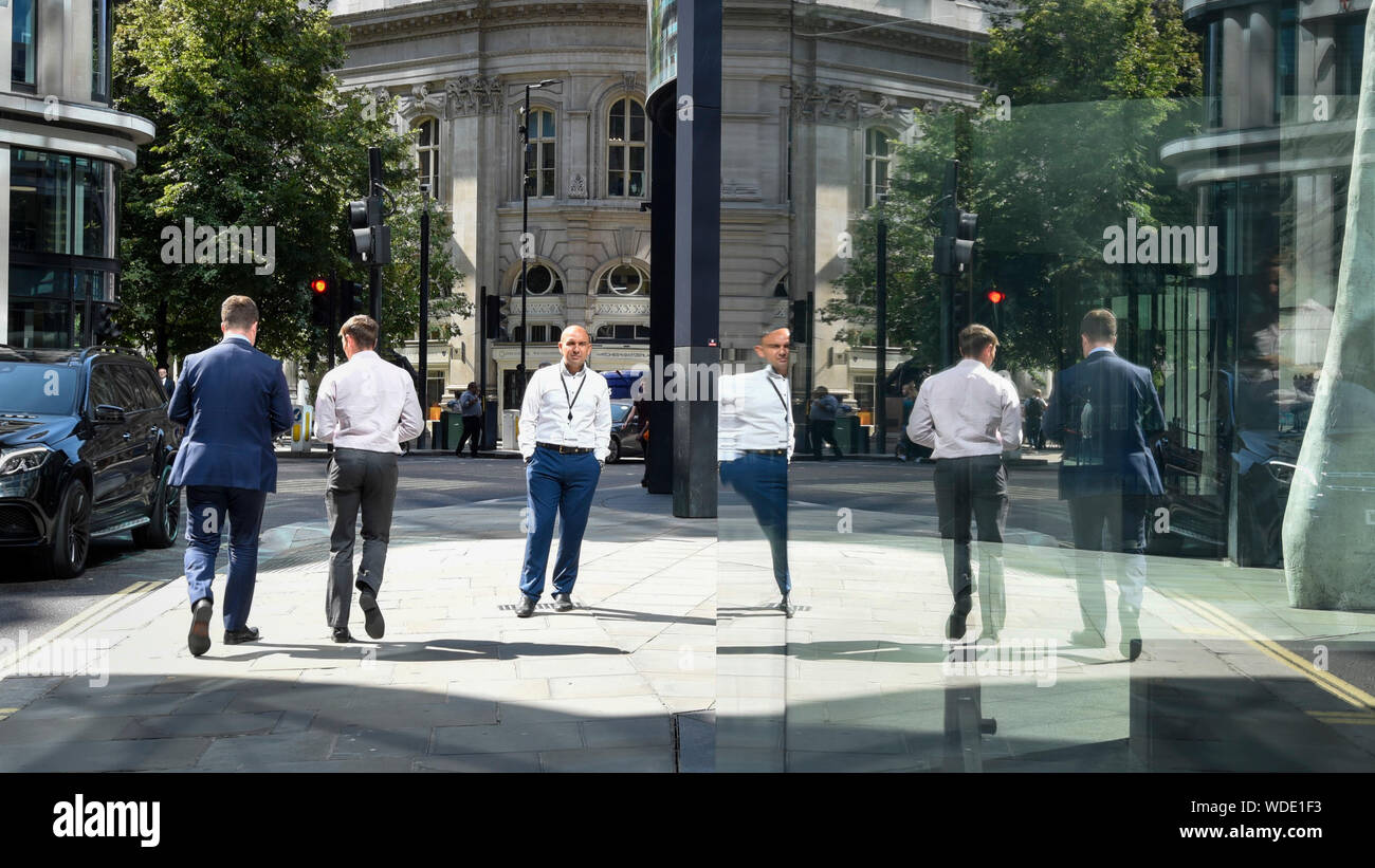 London, UK. 29 August 2019. UK Weather: Office workers are reflected in ...