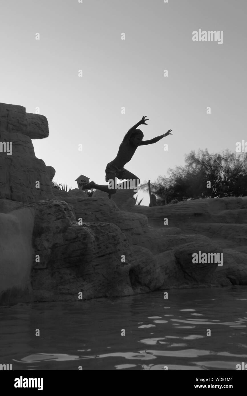 Boy jumping into pond hi-res stock photography and images - Alamy