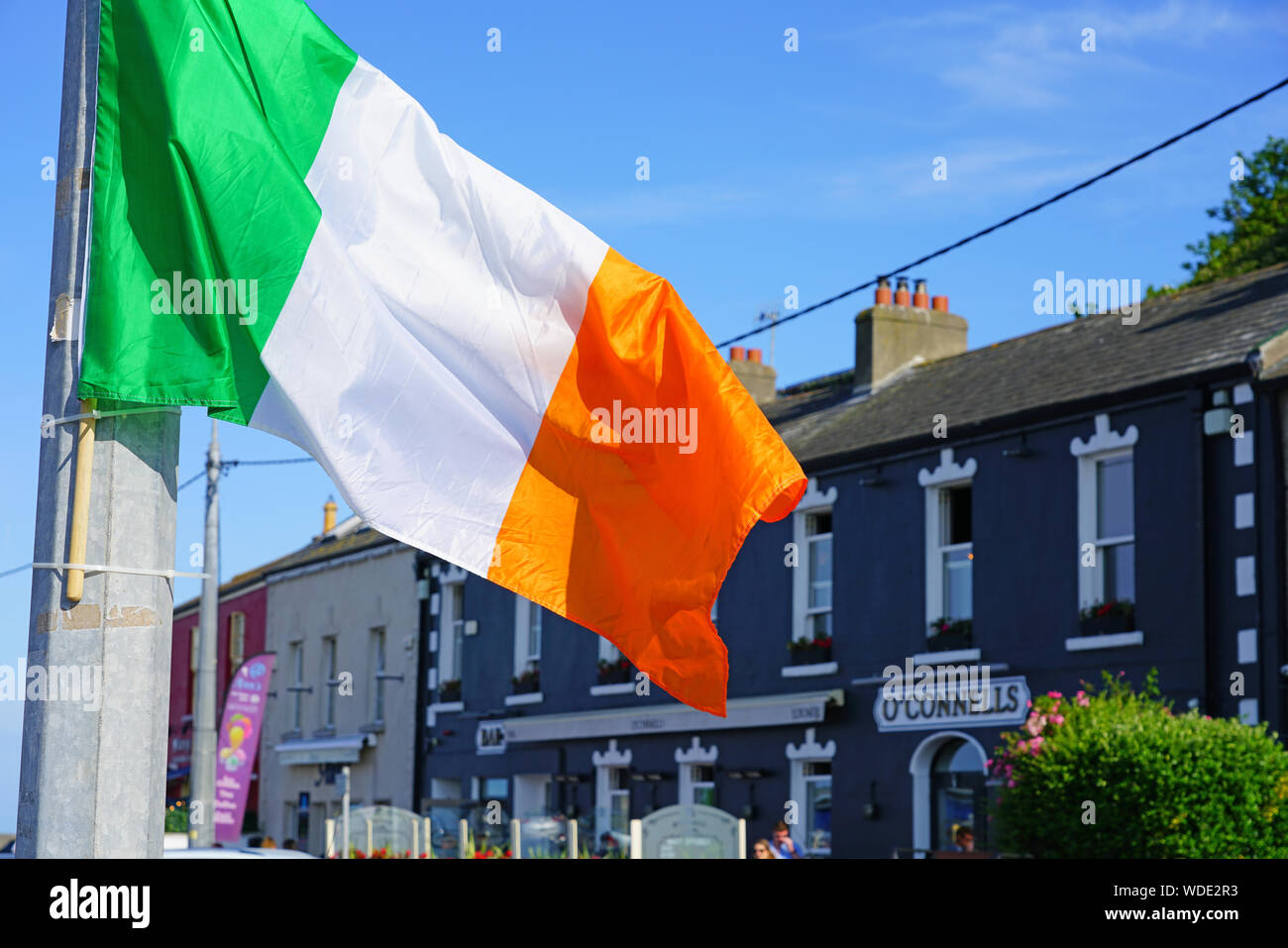 HOWTH, IRELAND- 27 JUL 2019- View of an Irish flag floating in the wind ...