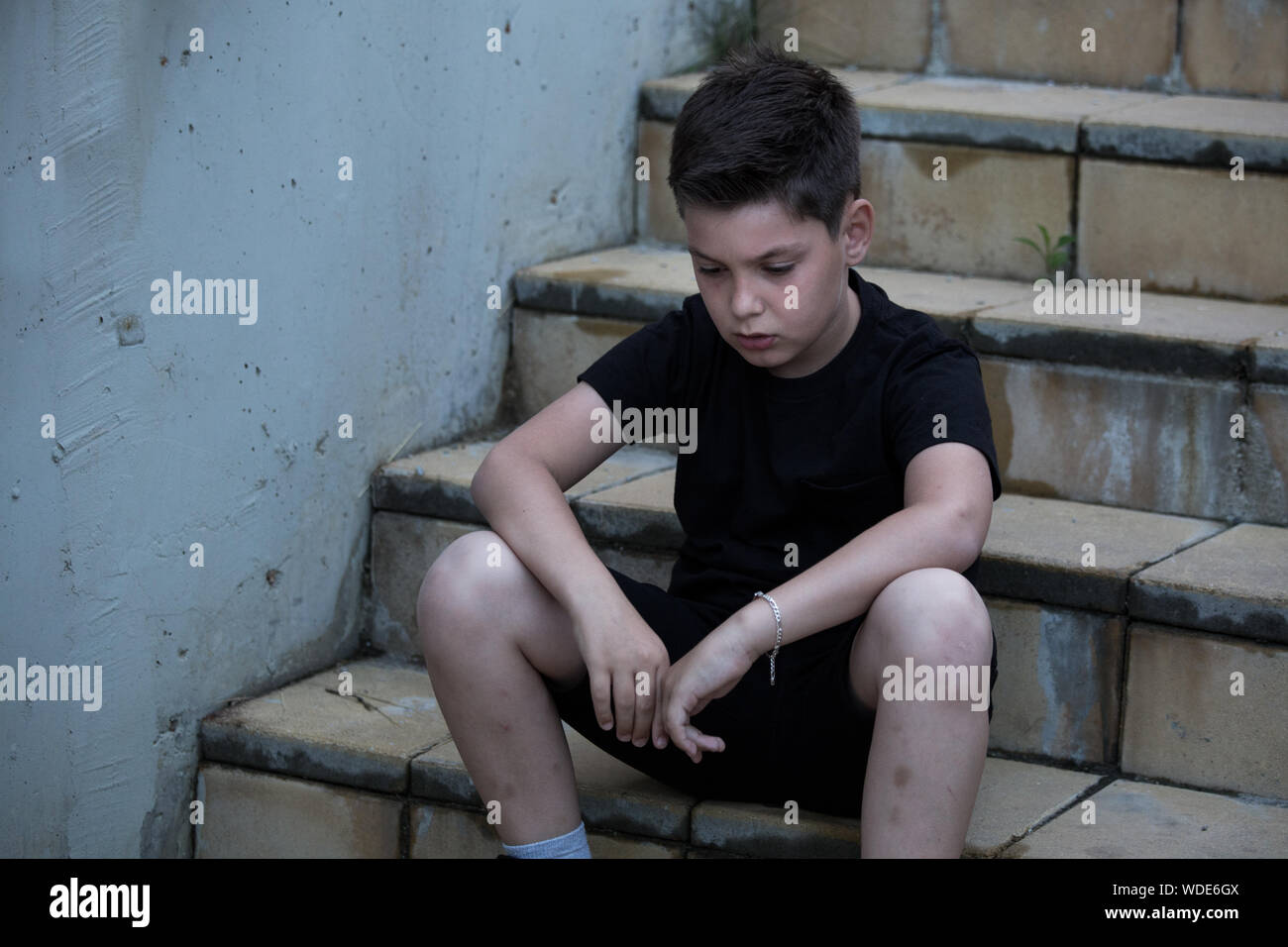 Portrait of a sad teenage boy looking thoughtful about troubles ...
