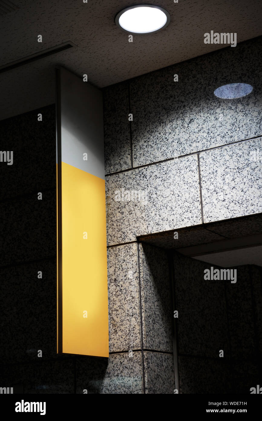 Concrete wall with grey and yellow sign Stock Photo - Alamy