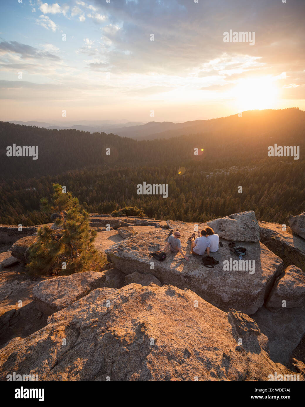 Three men sitting on rock hi-res stock photography and images - Alamy