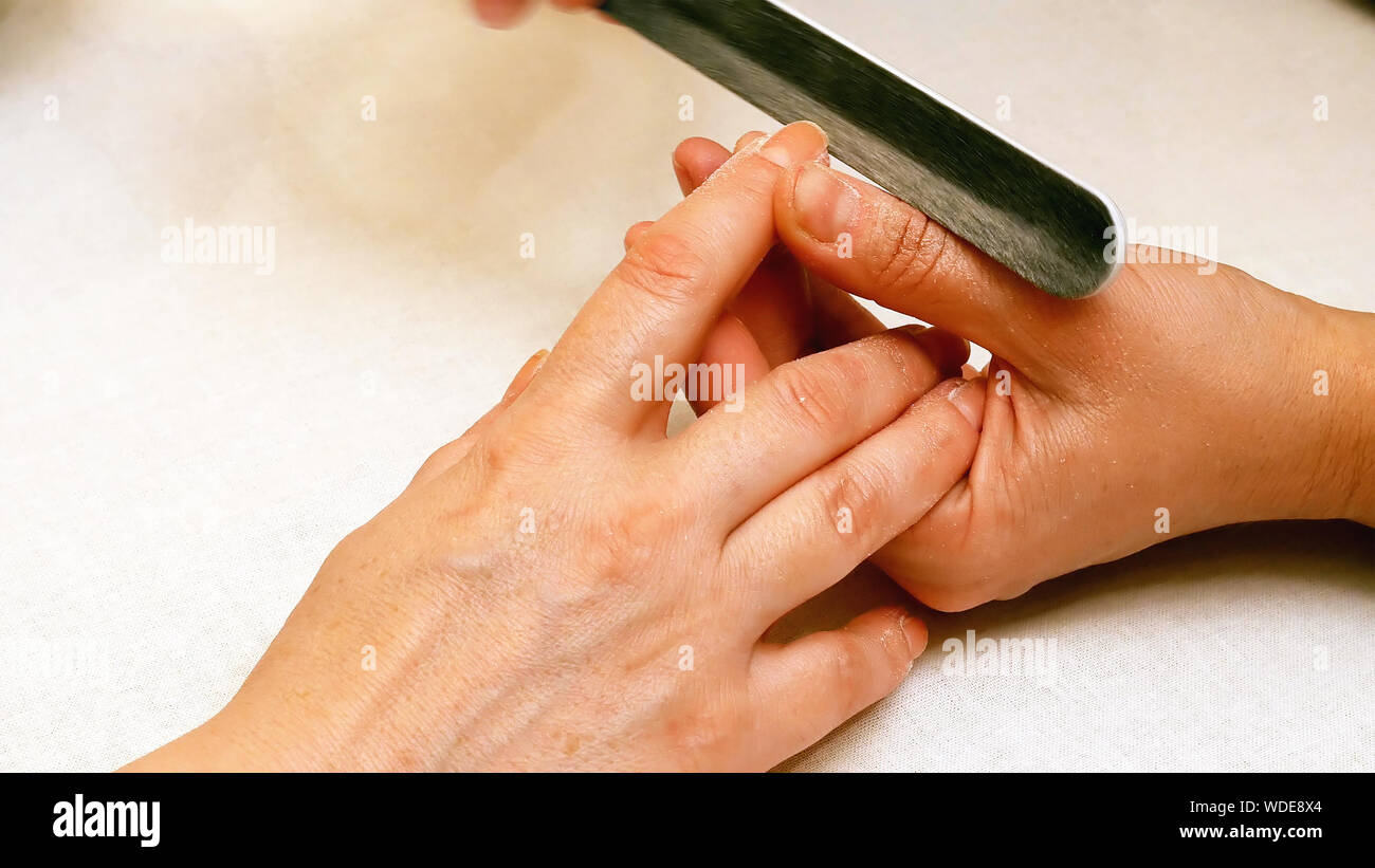 Woman filing nails hi-res stock photography and images - Alamy