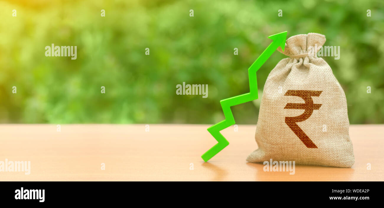 Money bag with indian rupee symbol and green up arrow. The growth of ...