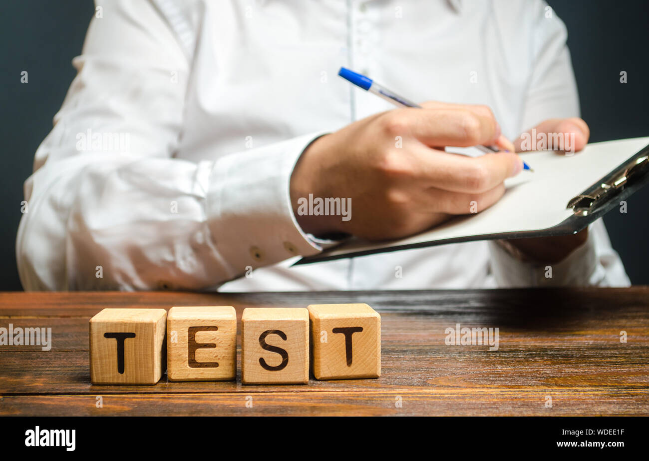Word test and a man with a clipboard in the background. Quality control ...
