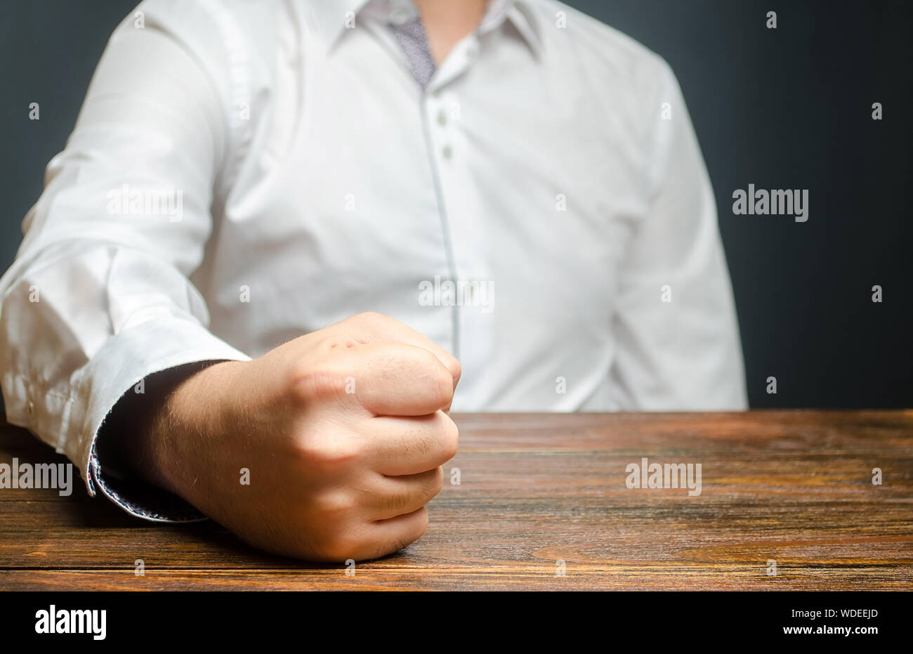 The man hit slammed his fist on the table. The end of patience. It is ...