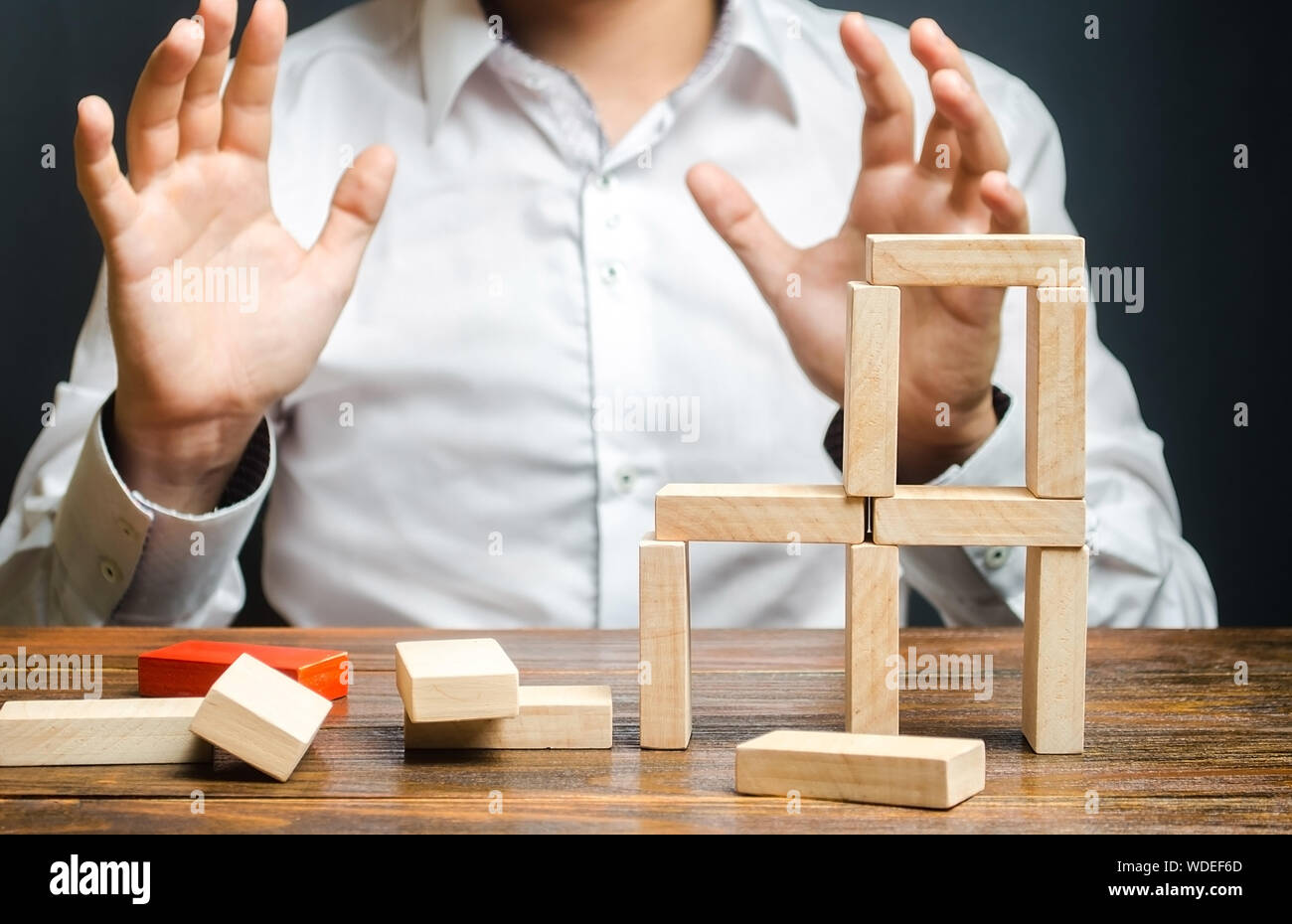 The man looks frightened at the collapse of the constructed structure ...