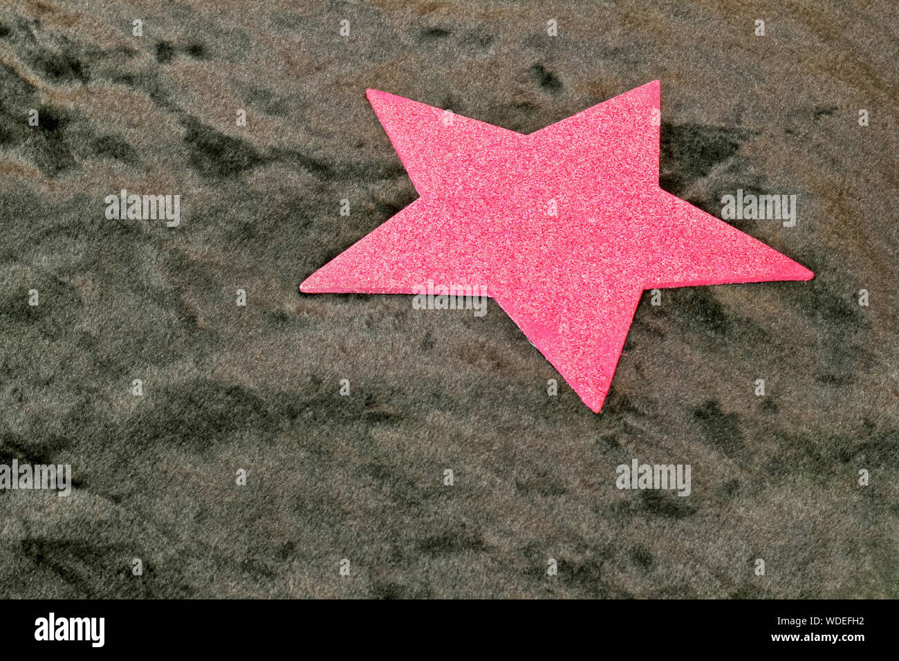 Pink shiny star shape with black background Stock Photo - Alamy