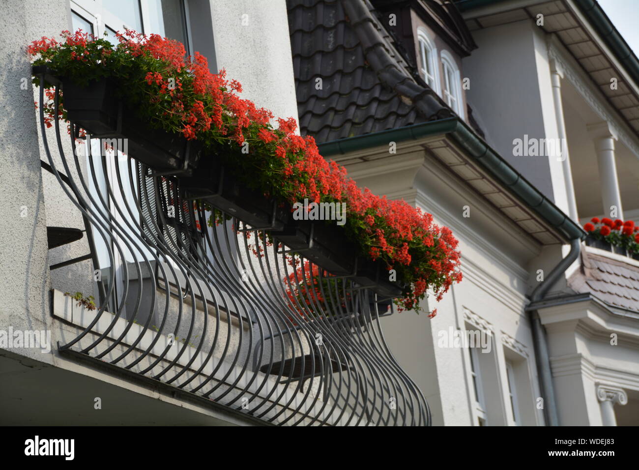 Balcony with red flowers hi-res stock photography and images - Alamy