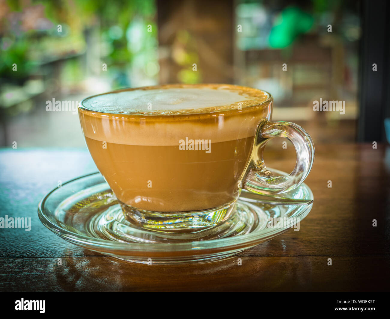 Side view latte art coffee on wood table Stock Photo - Alamy