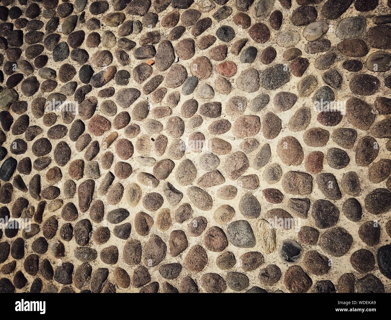Color image of a pavement made of round stones Stock Photo - Alamy