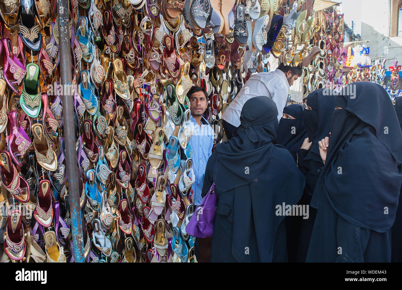 India, Telengana, Hyderabad, Muslim women view the goods on dispay at a ...