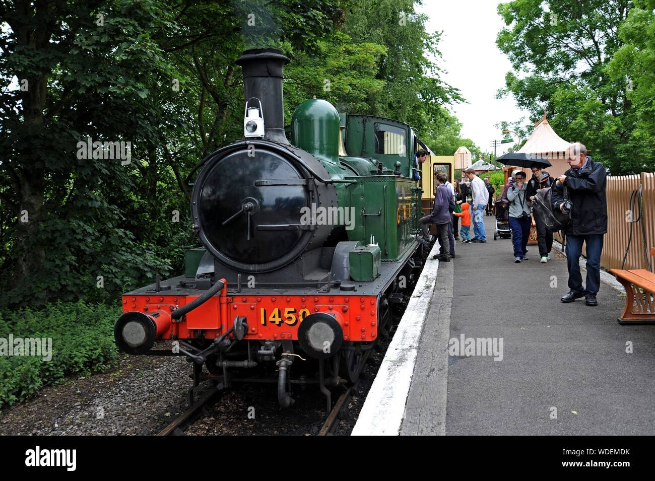 Passengers leave a train pulled by GWR 14xx class No 1450 with a GWR ...
