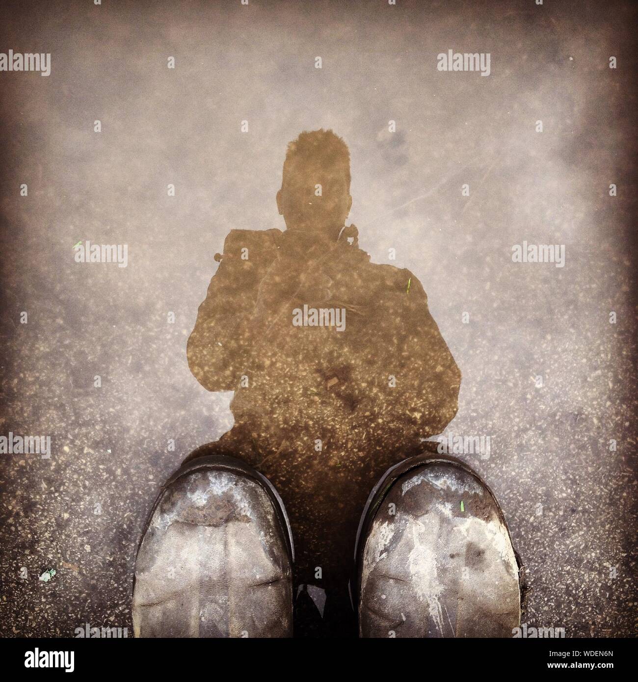 Shoes in puddle hi-res stock photography and images - Alamy