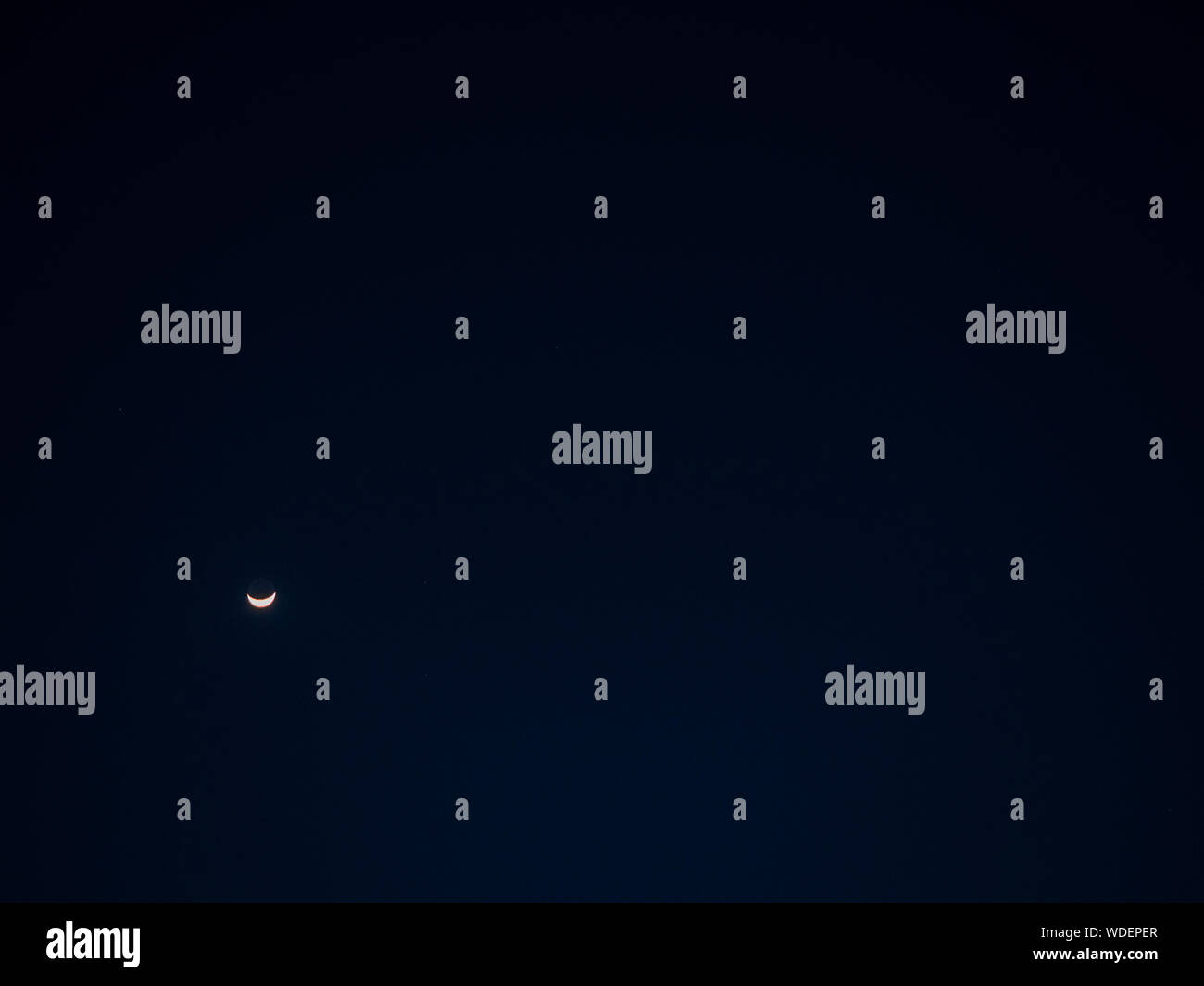 a shining crescent moon in dark sky Stock Photo - Alamy