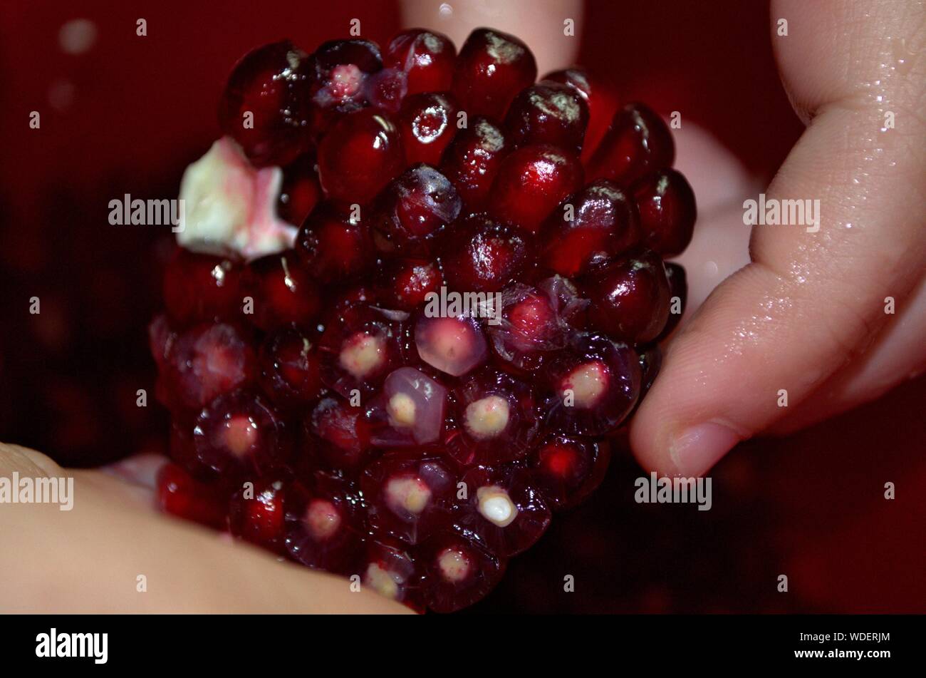 Hand holding pomegranate hi-res stock photography and images - Alamy
