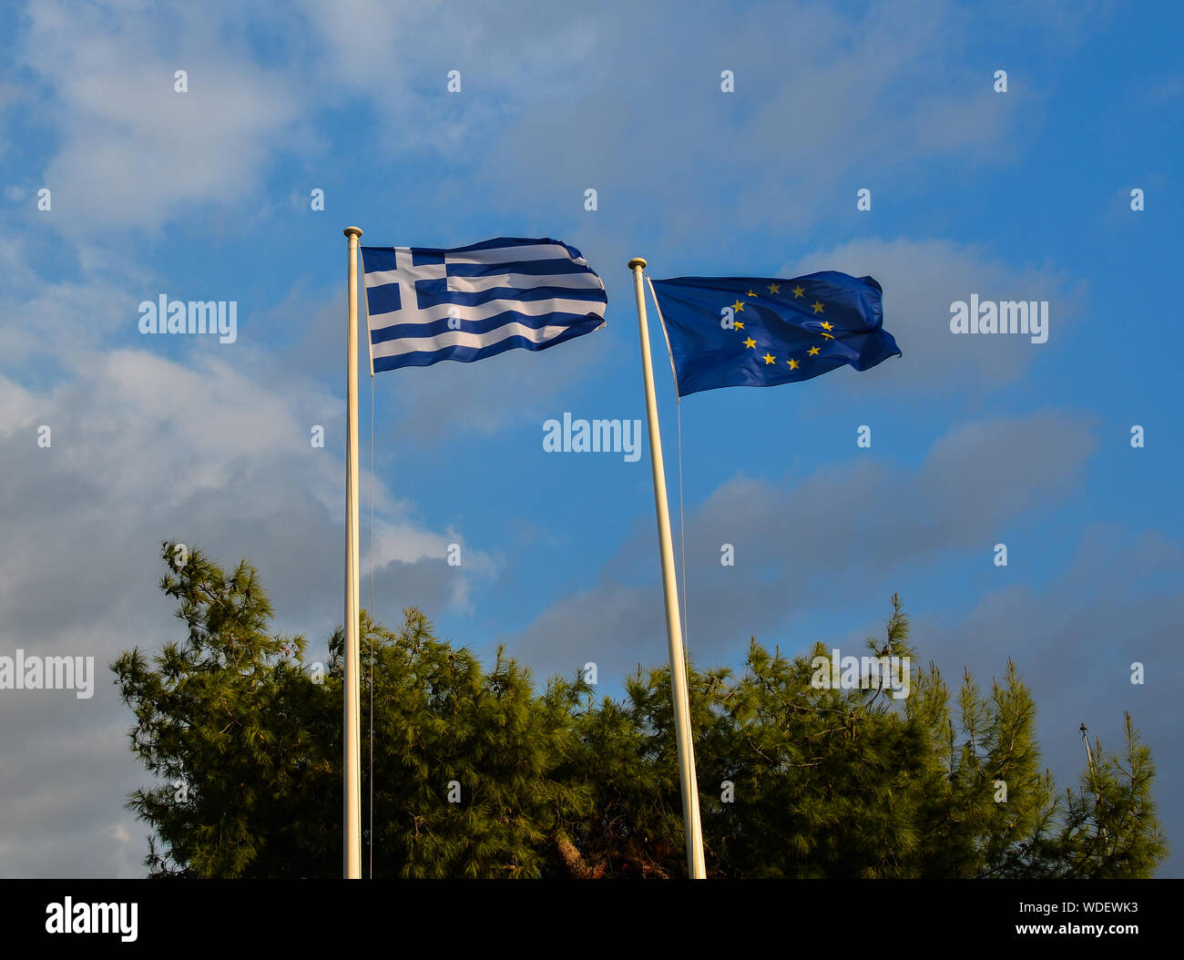 Greek flag and blue European Union flags under the blue sky Stock Photo ...