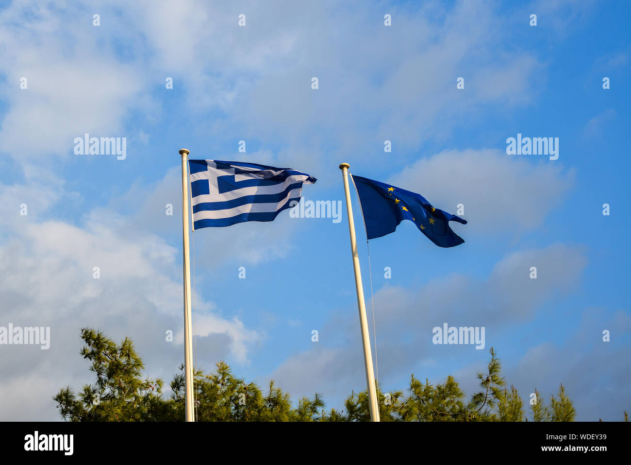 Greek flag and blue European Union flags under the blue sky Stock Photo ...
