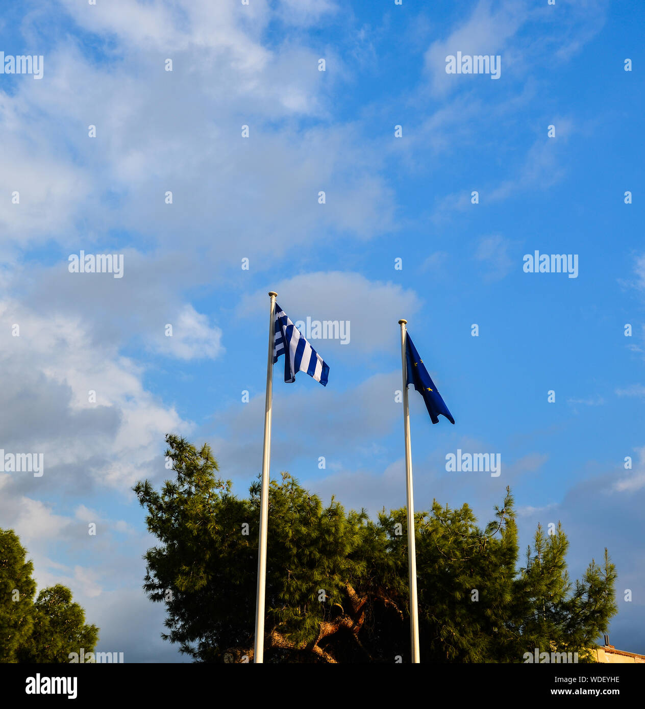 Greek flag and blue European Union flags under the blue sky Stock Photo ...