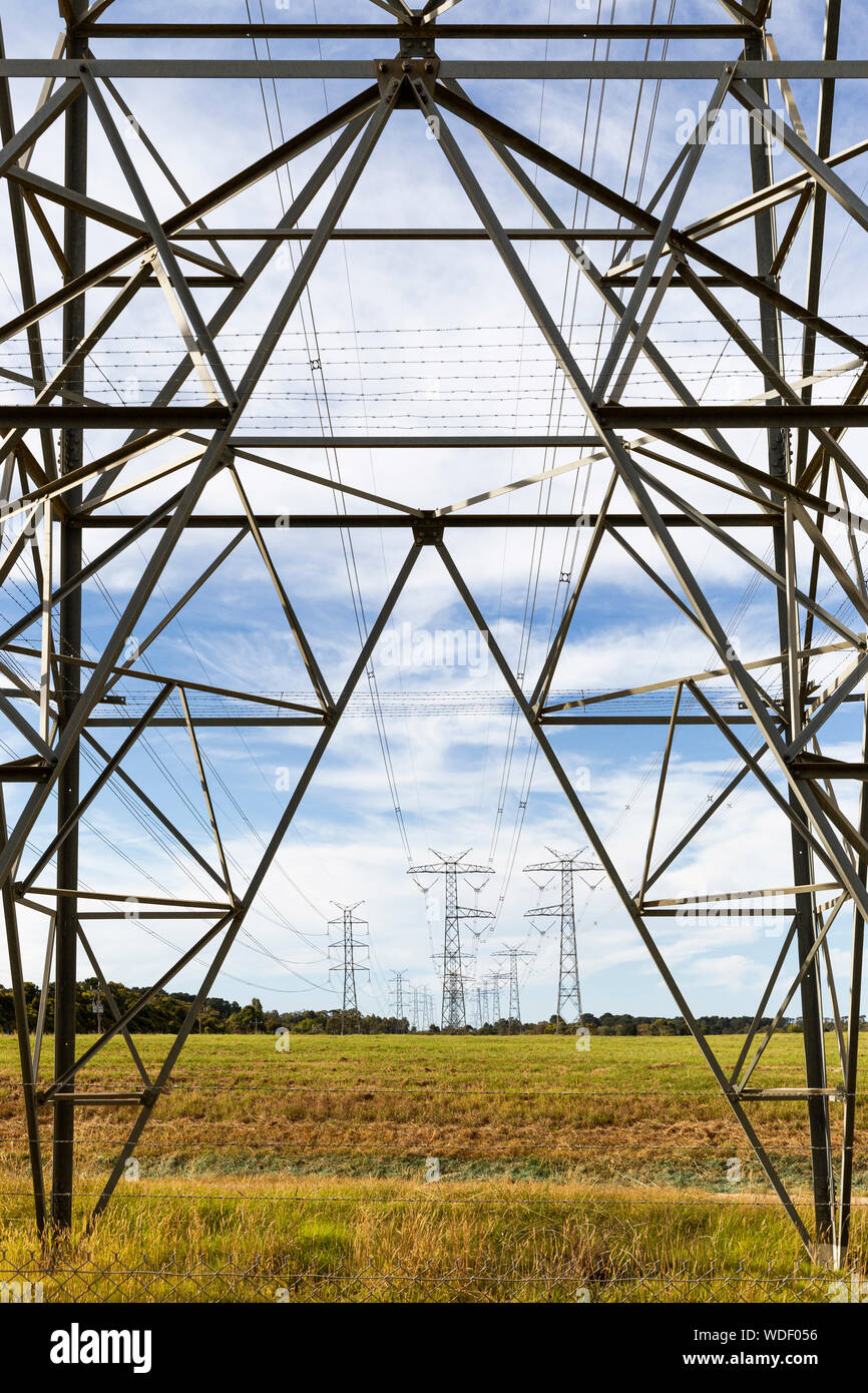 Pylon architecture chained into the distance Stock Photo - Alamy