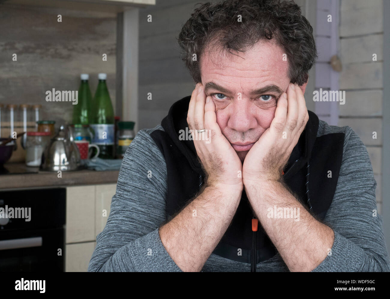 Sad man sitting at home hi-res stock photography and images - Alamy
