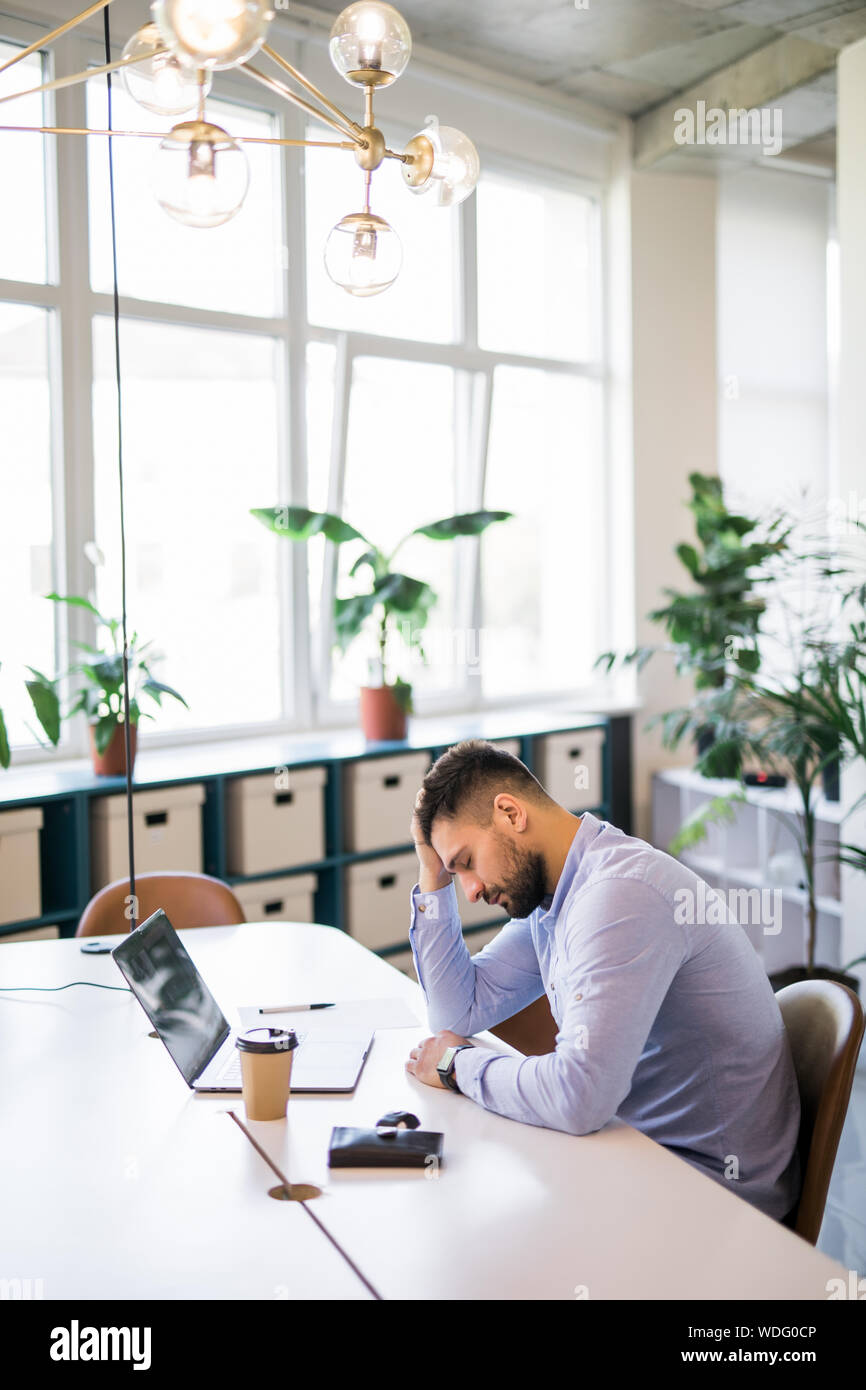 A young desperate businessman in his office looking down Stock Photo ...