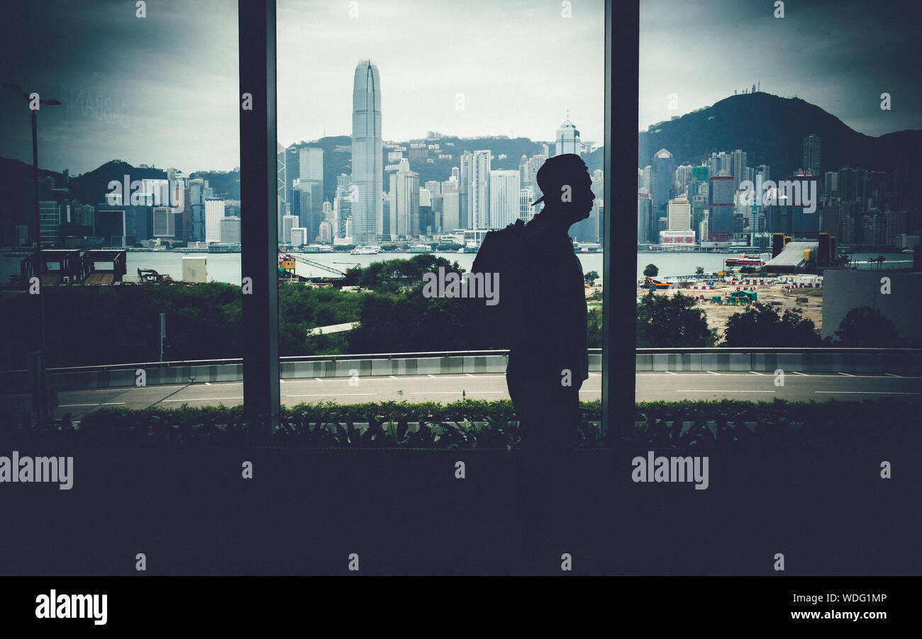 Silhouette Man Walking By Glass Window Stock Photo - Alamy