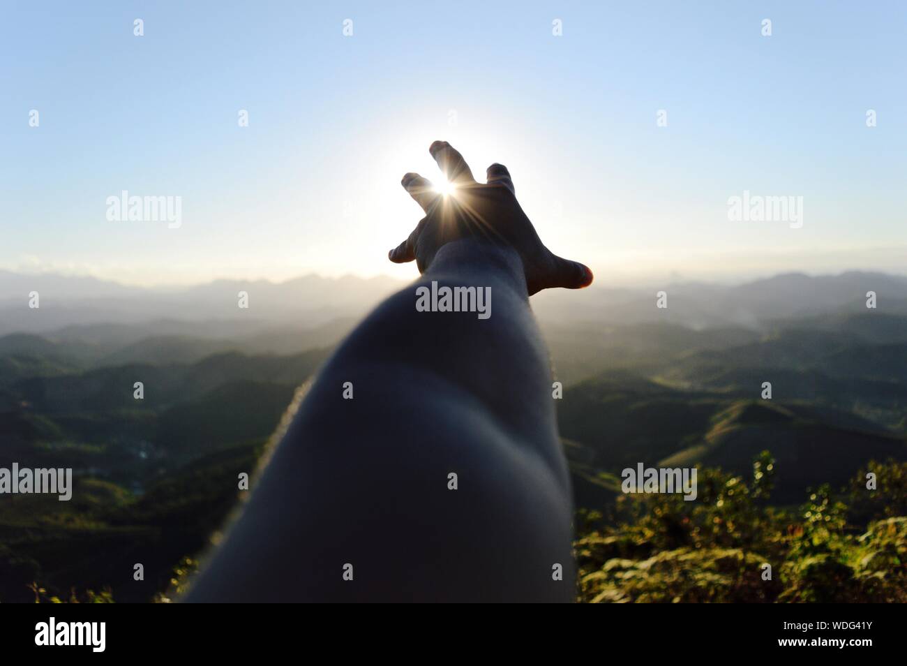 Hand reaching towards sunlight hi-res stock photography and images - Alamy