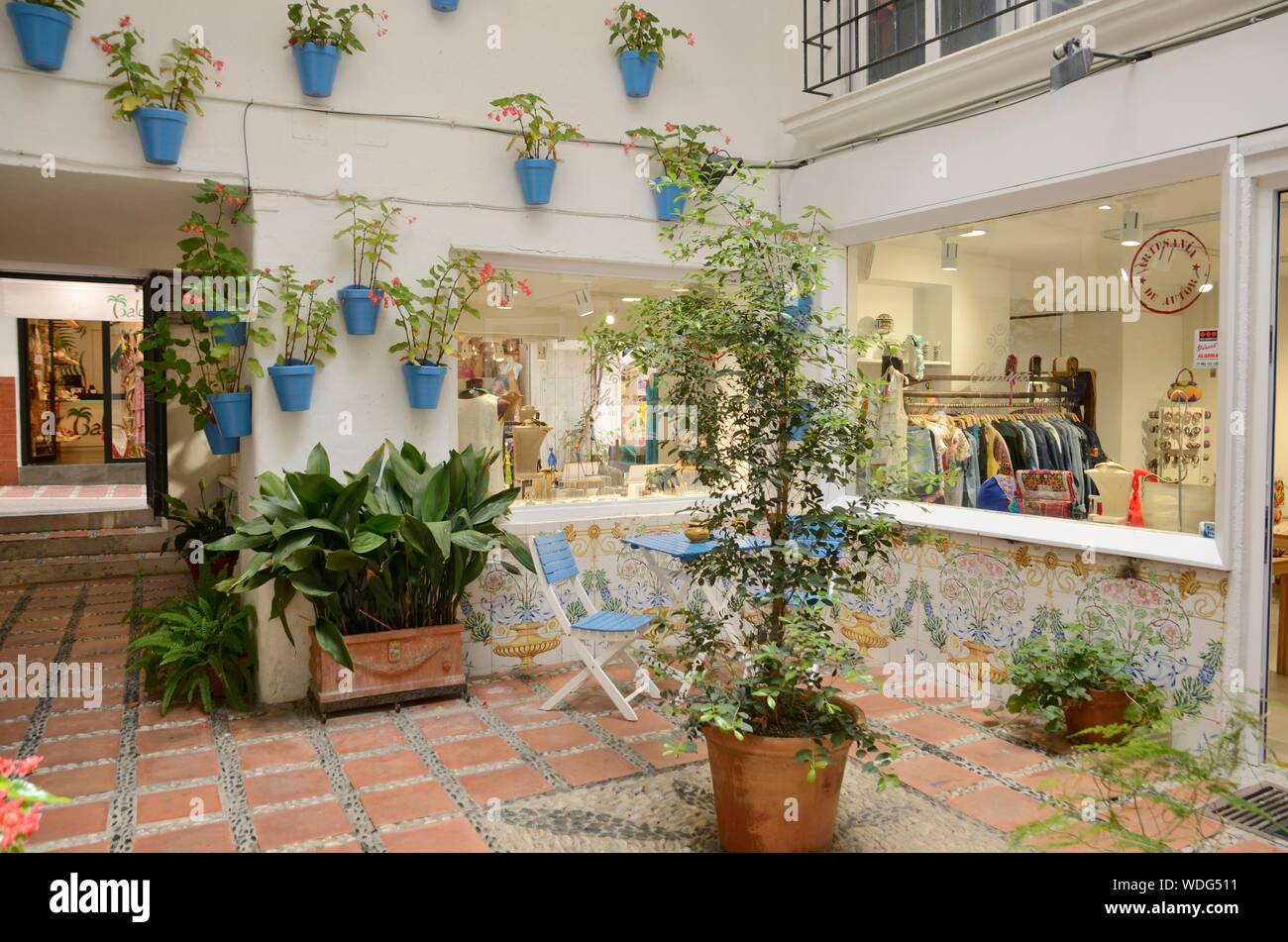 Marbella, Spain - August 12, 2019: Blue pots on wall at patio in the ...