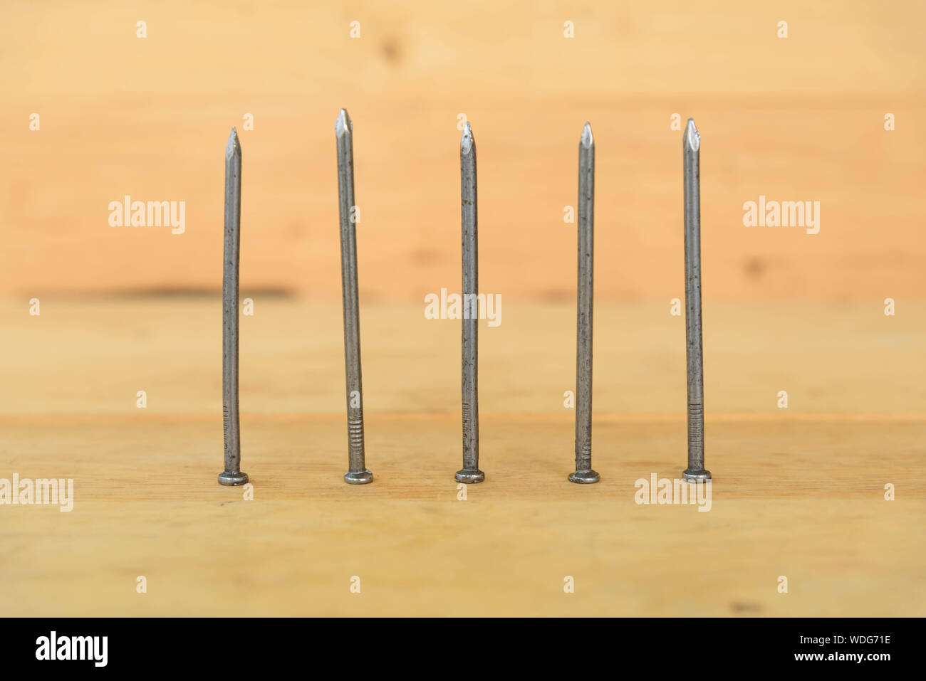 nail on the wood board Stock Photo - Alamy