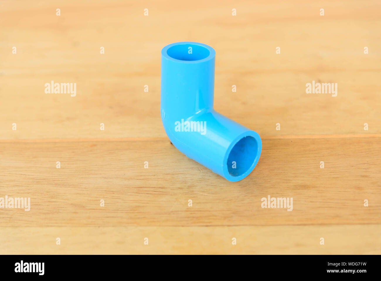 PVC elbow shape on wood plate Stock Photo - Alamy