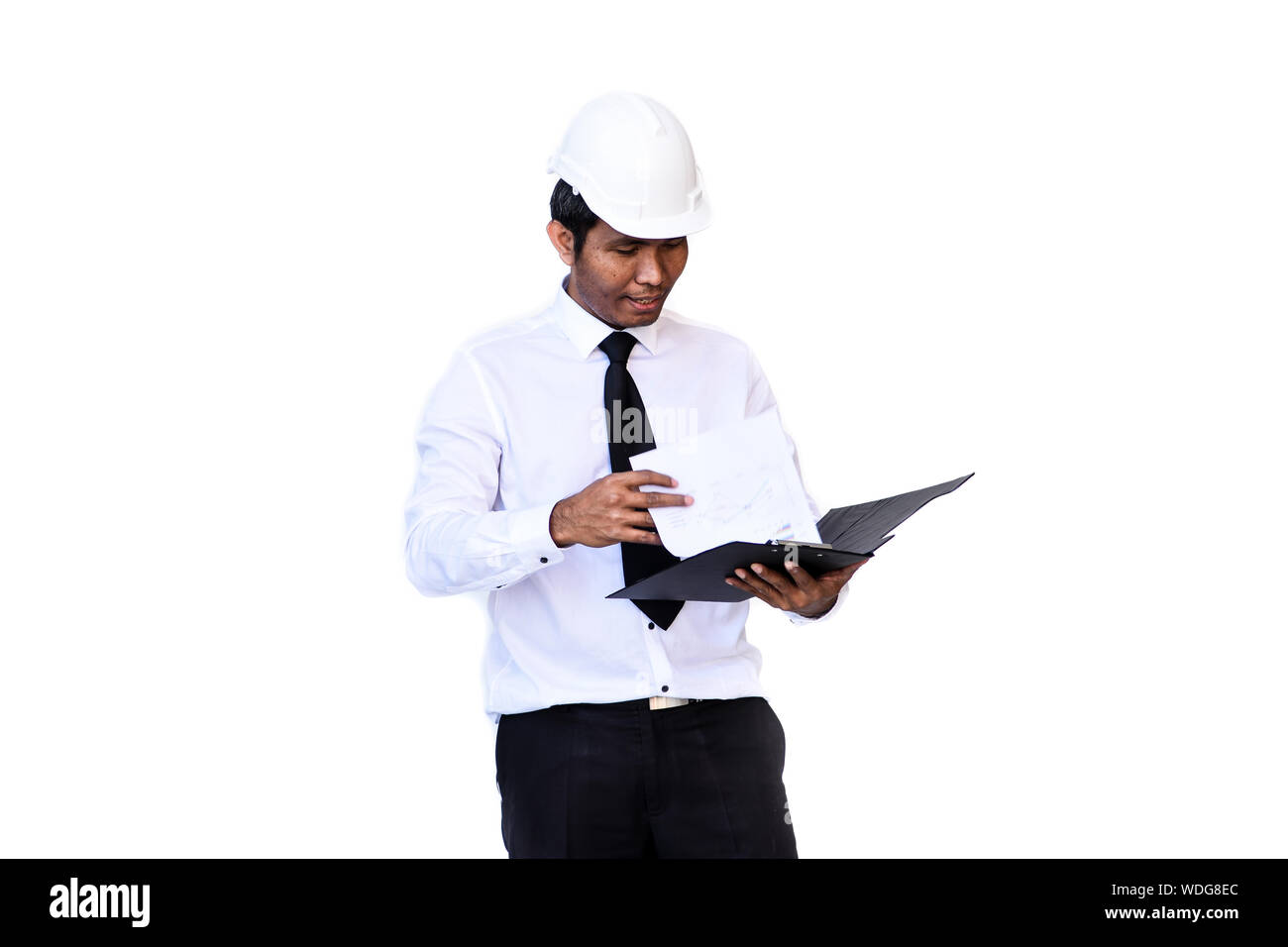 Engineer Reading Document While Standing Against White Background Stock ...
