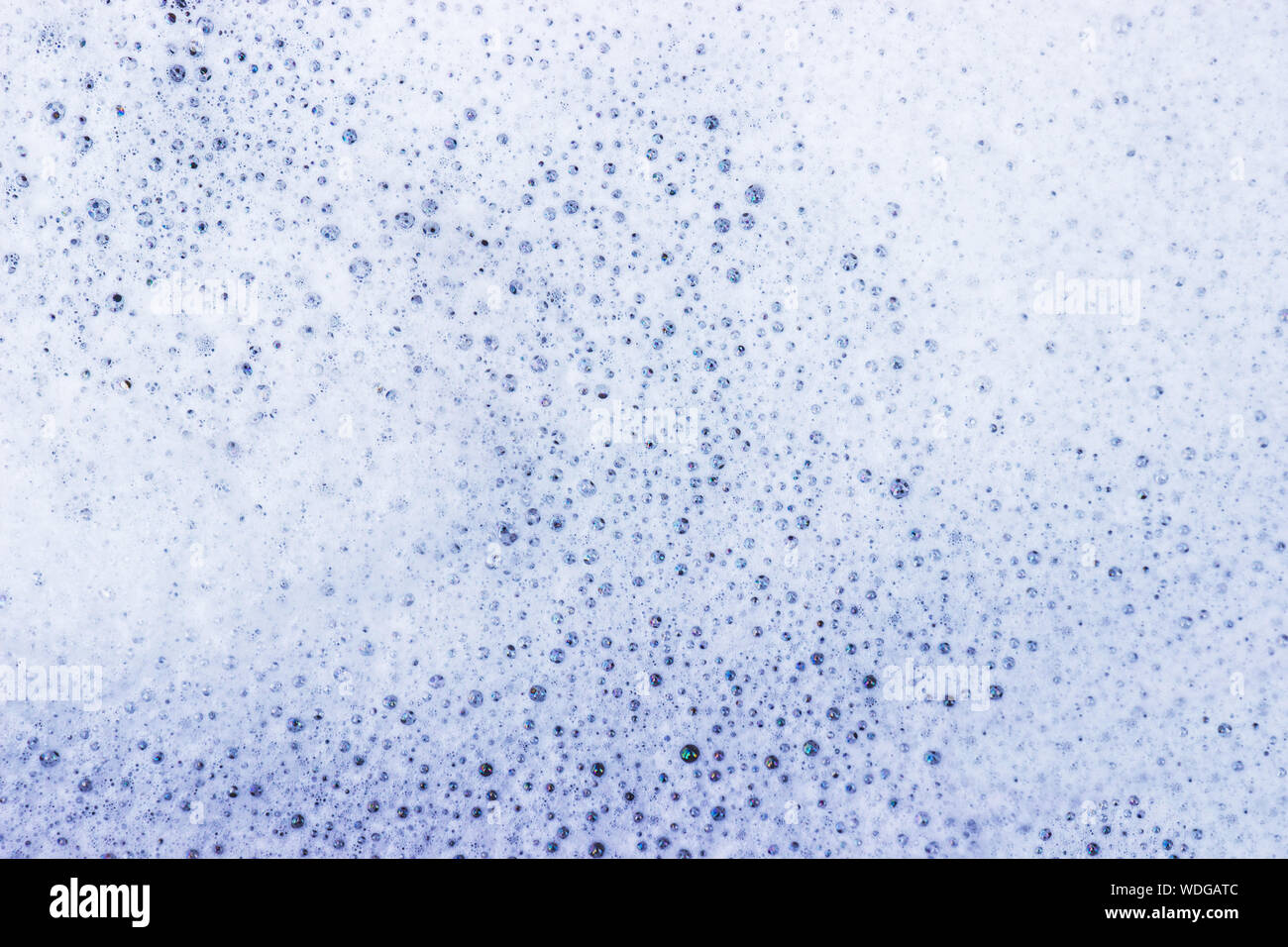 White bubble of detergent in blue container for background. Abstract ...