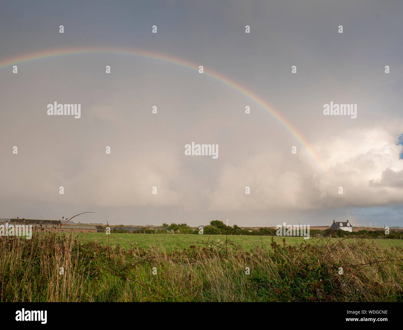 A rainbow over an isolated house at Porthcothan Bay Cornwall UK Stock ...