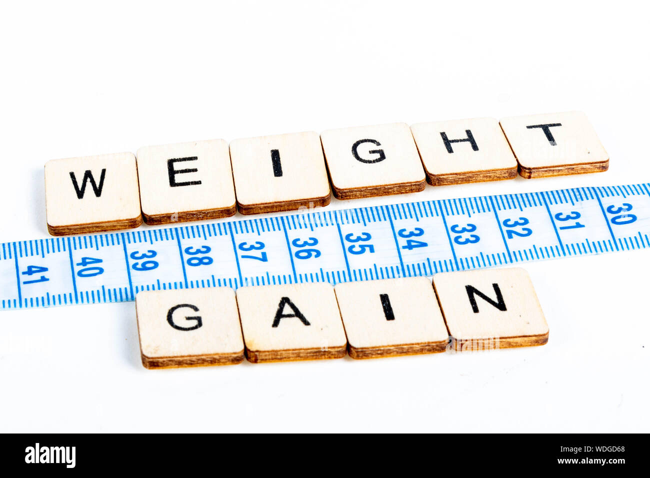 Health concept of a tape measure also showing the message Weight Gain ...