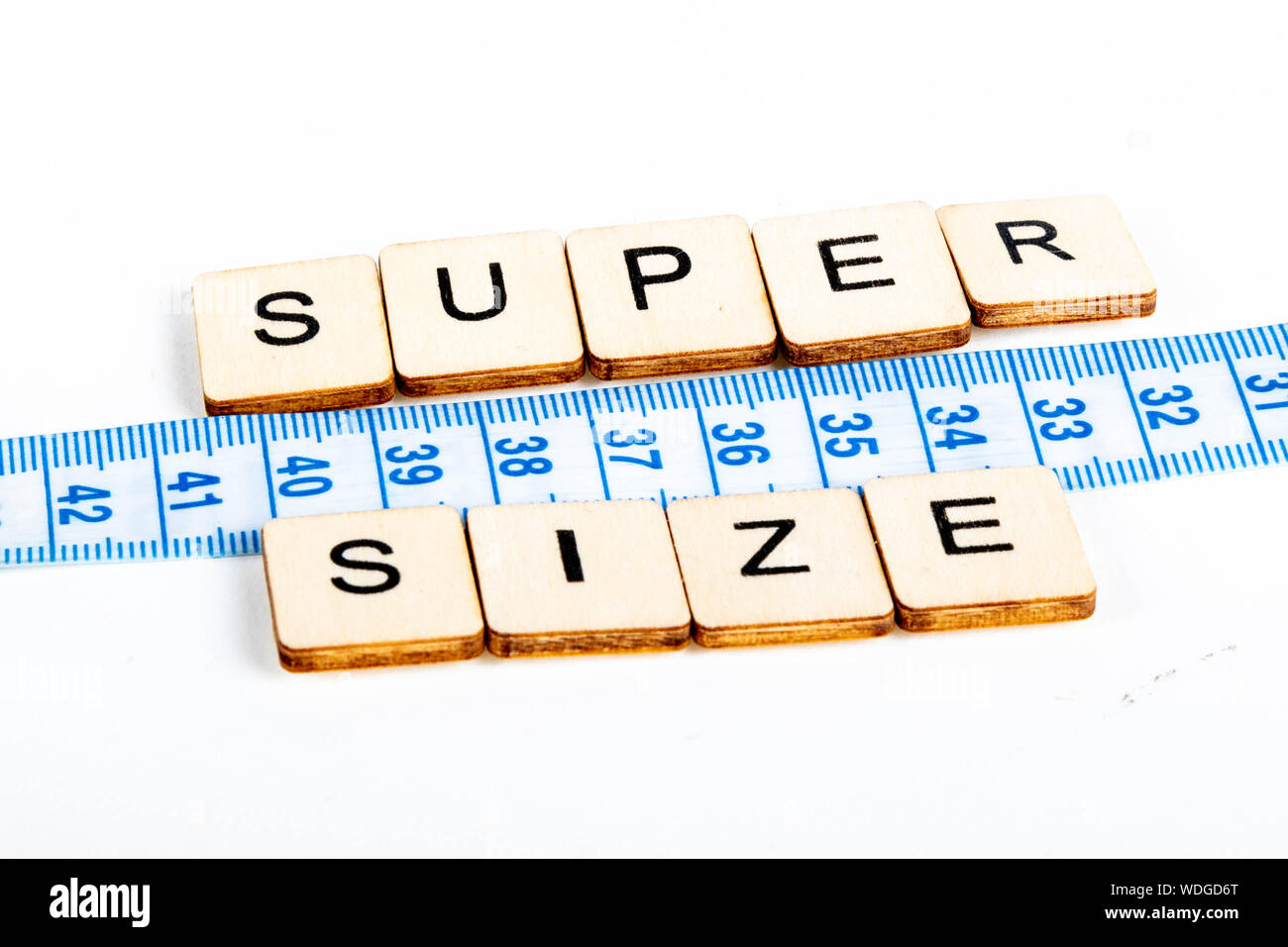Health concept of a tape measure also showing the message Super Size ...