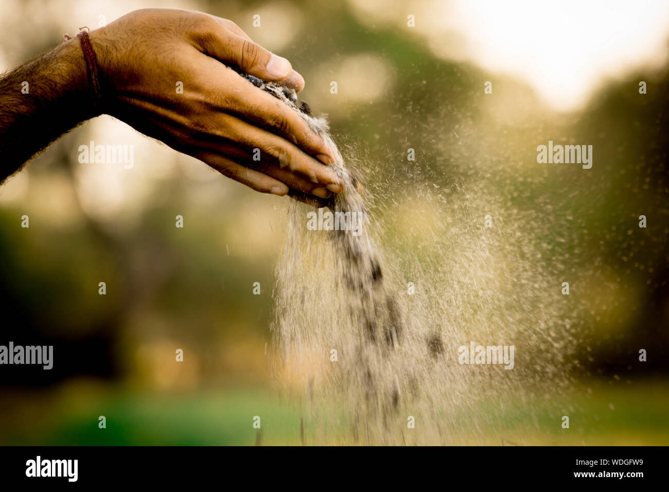 Hand pouring sand hi-res stock photography and images - Alamy