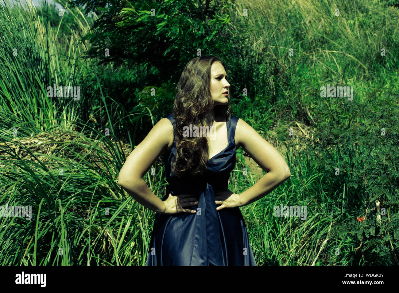 Woman standing akimbo hi-res stock photography and images - Alamy