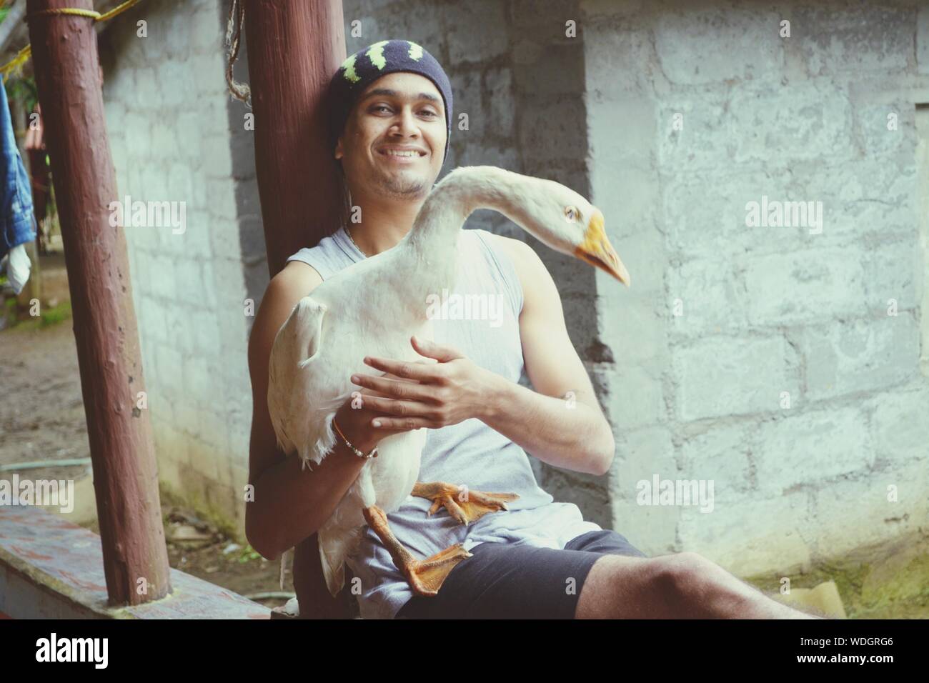 Portrait of young man sitting on railing hi-res stock photography and ...