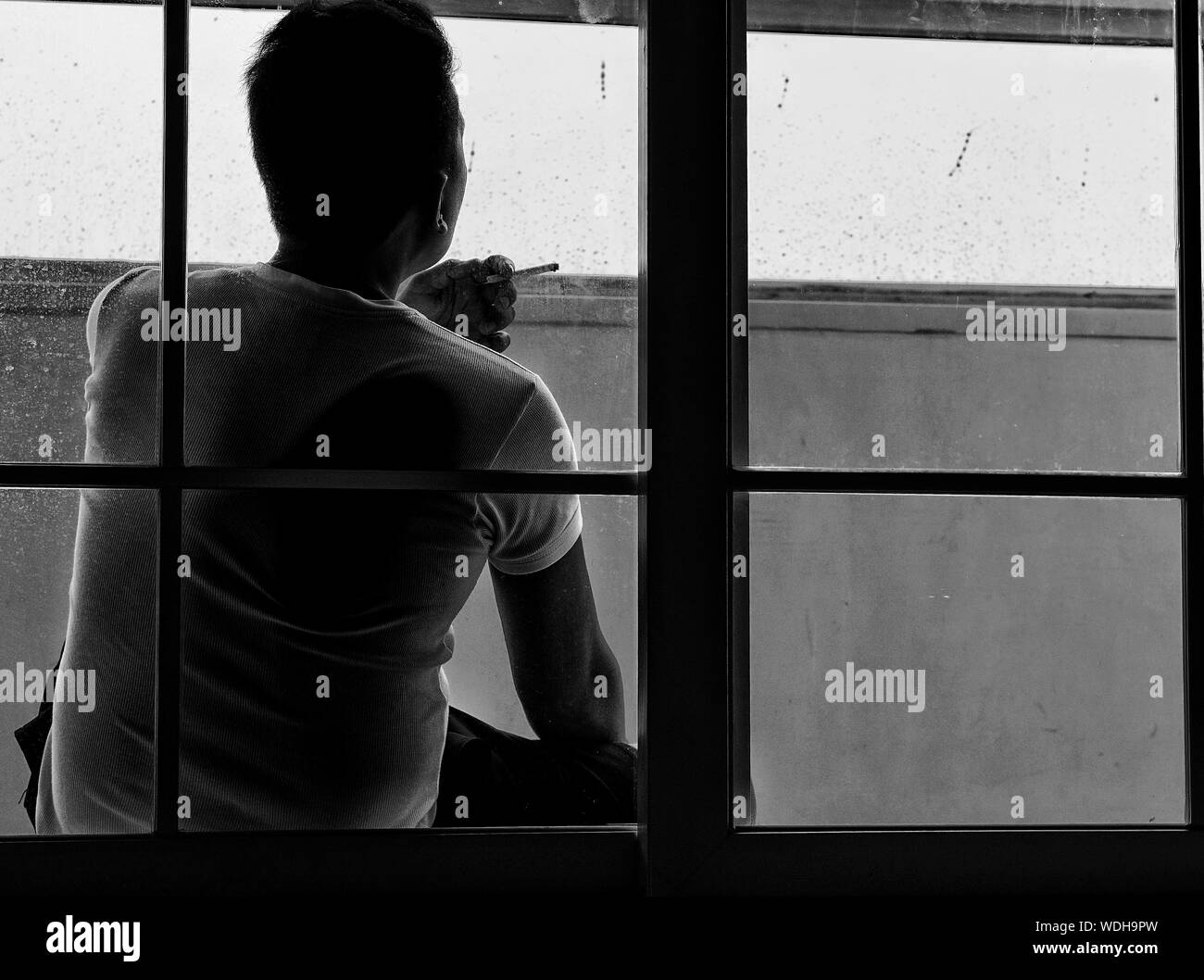 Smoking man at the window Black and White Stock Photos & Images - Alamy