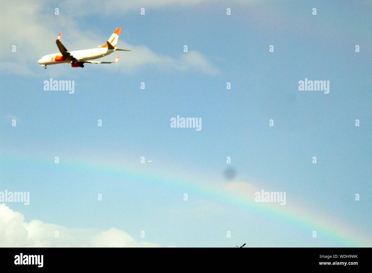 Airplane Over Rainbow Stock Photo - Alamy