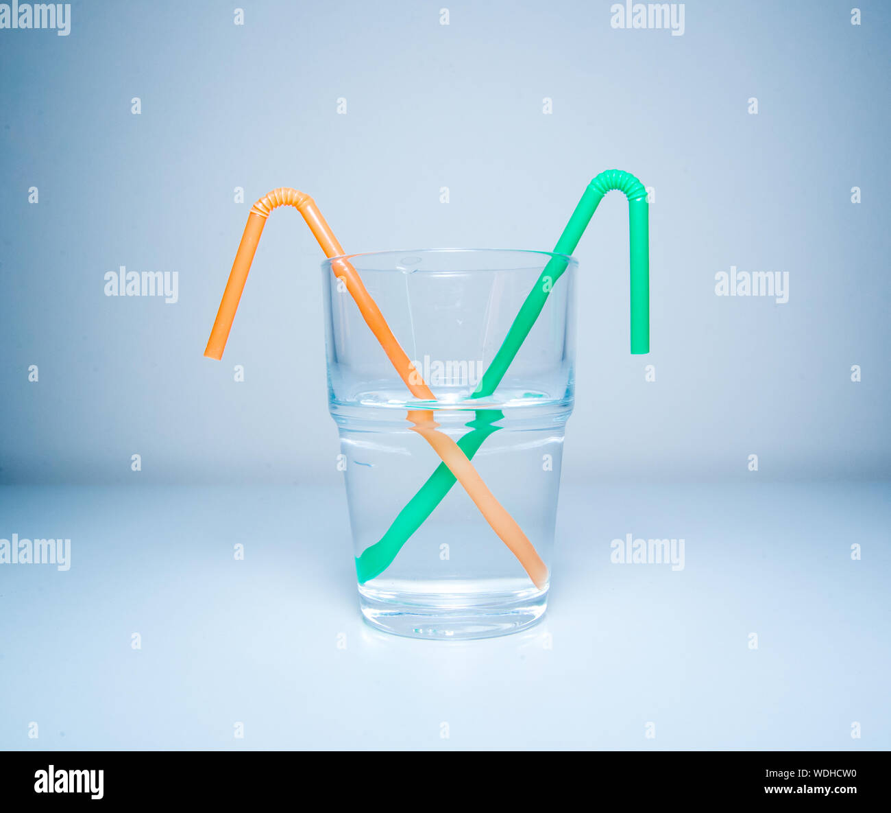 Two plastic straws in a glass of water Stock Photo - Alamy
