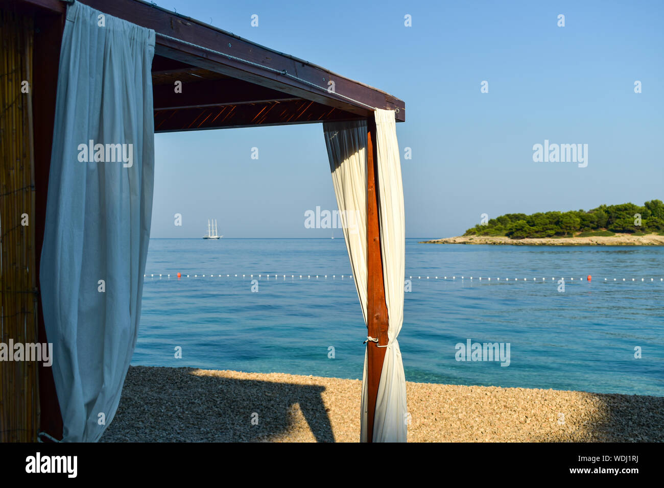Romantic and luxury beach canopy with a boat and an island in ...