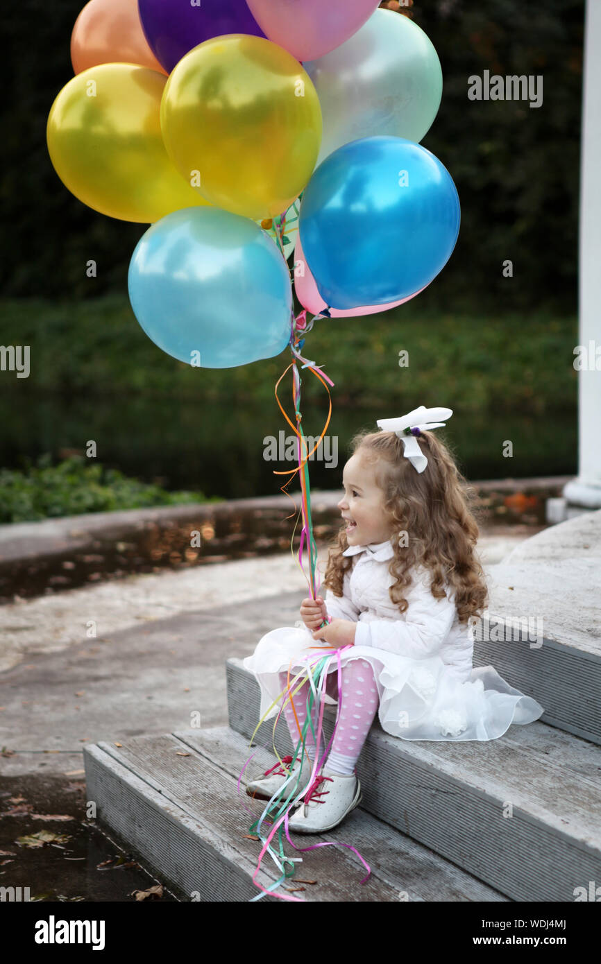 Girl Sitting Balloons High Resolution Stock Photography and Images - Alamy