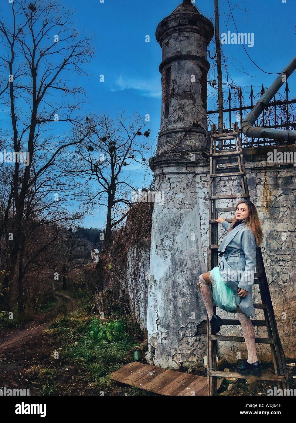 Woman climbing ladder hi-res stock photography and images - Alamy